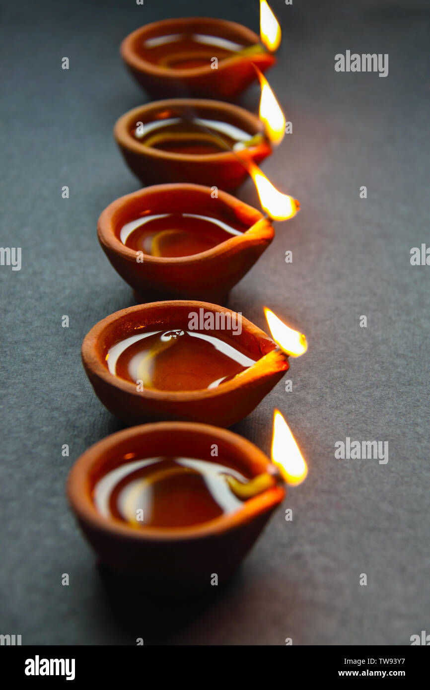 Diwali diyas burning in a row Stock Photo - Alamy