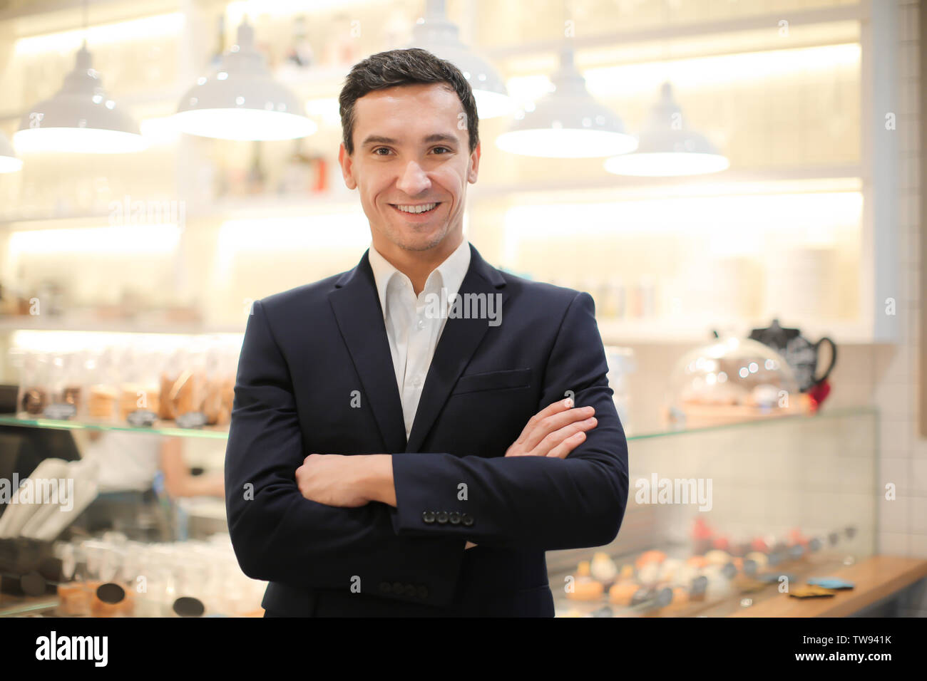 Young male business owner in clothes shop hi-res stock photography and ...