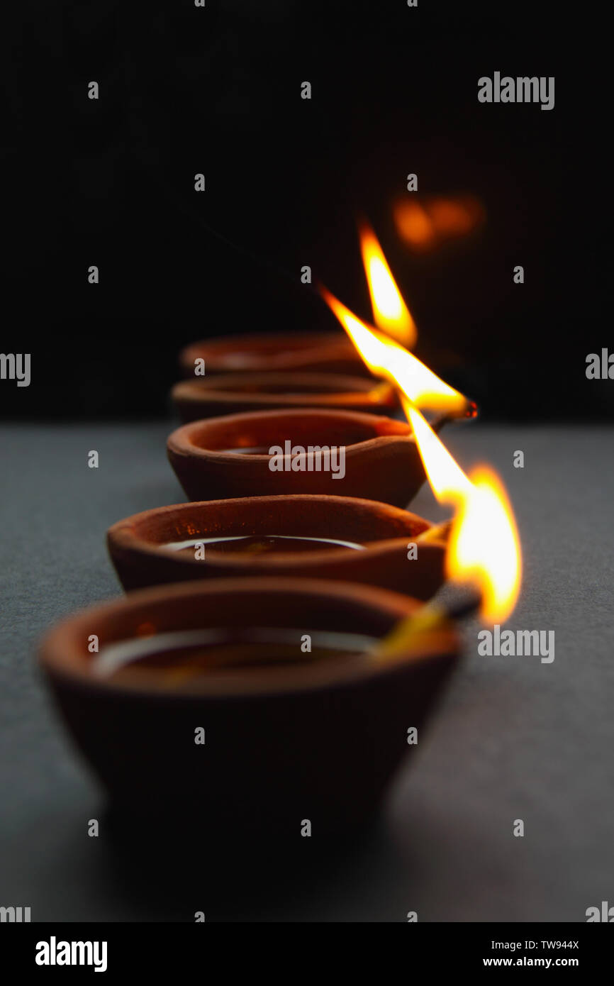 Diwali diyas burning in a row Stock Photo - Alamy