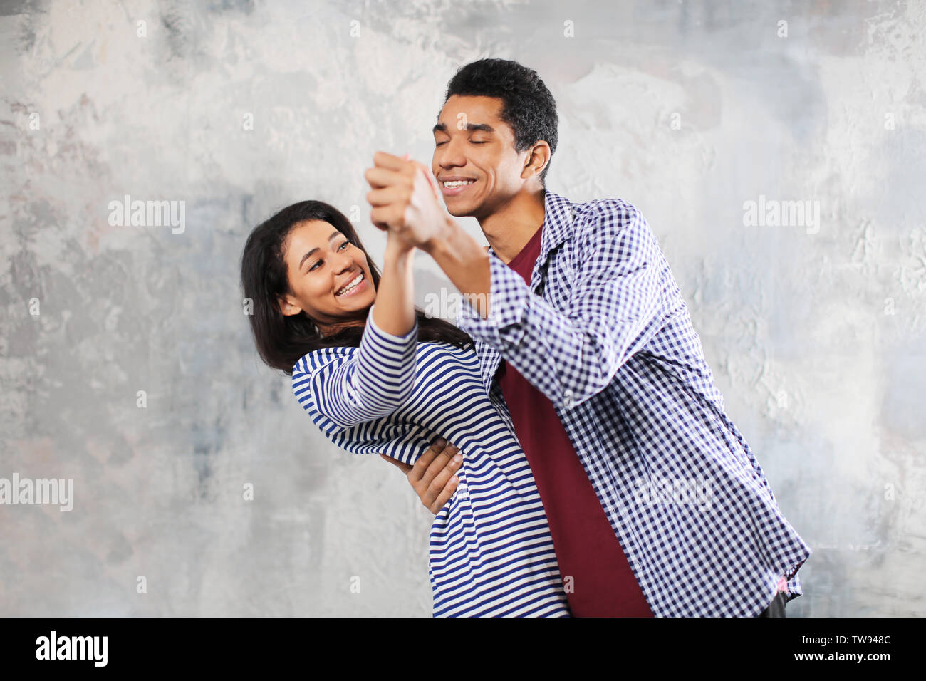 Attractive African-American couple dancing at home Stock Photo - Alamy