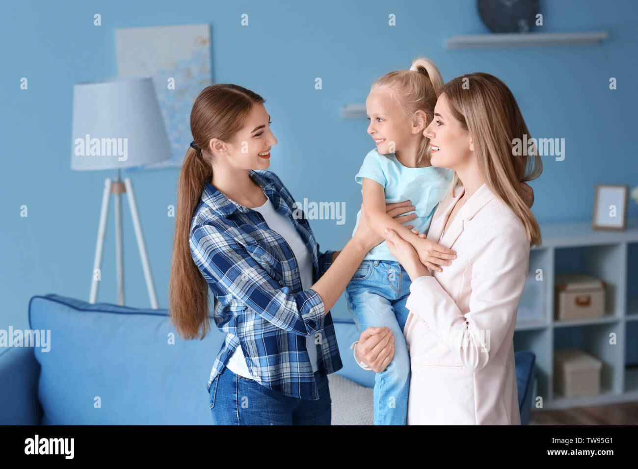 Mother leaving her daughter with nanny at home Stock Photo - Alamy