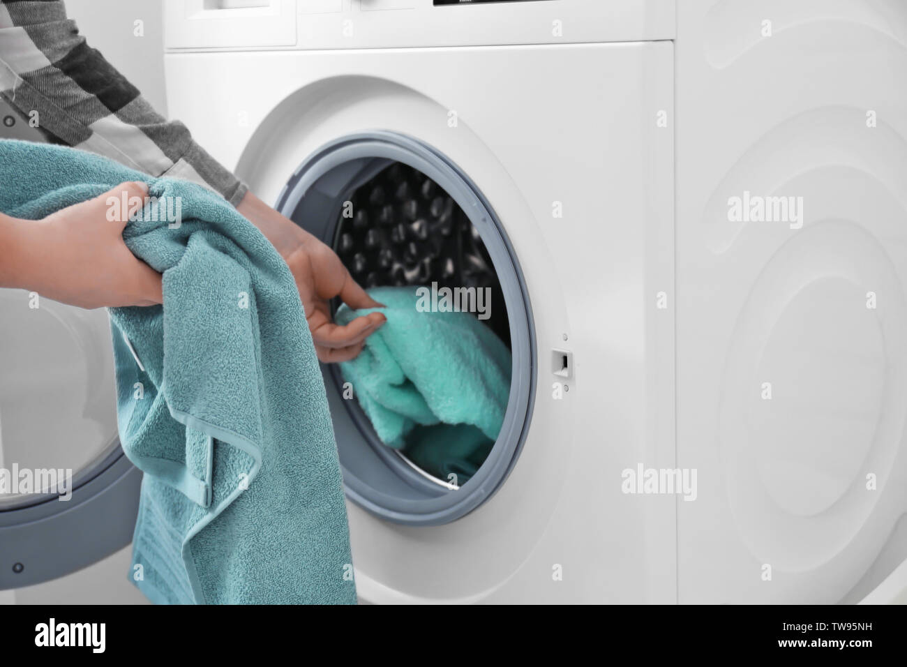 Loading washing machine industrial machine hi-res stock photography and ...