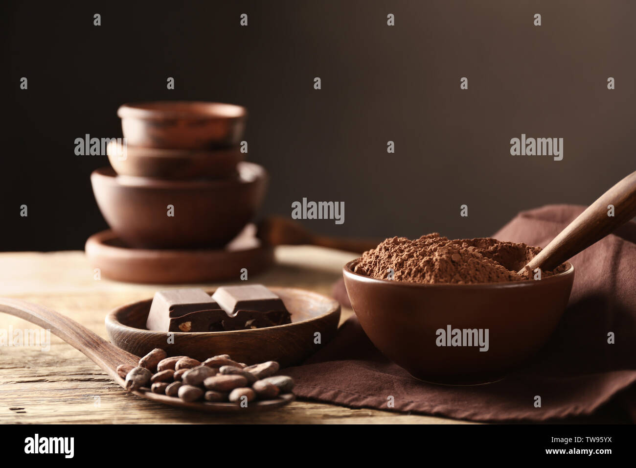 Tasty chocolate, cocoa powder and beans on table Stock Photo - Alamy