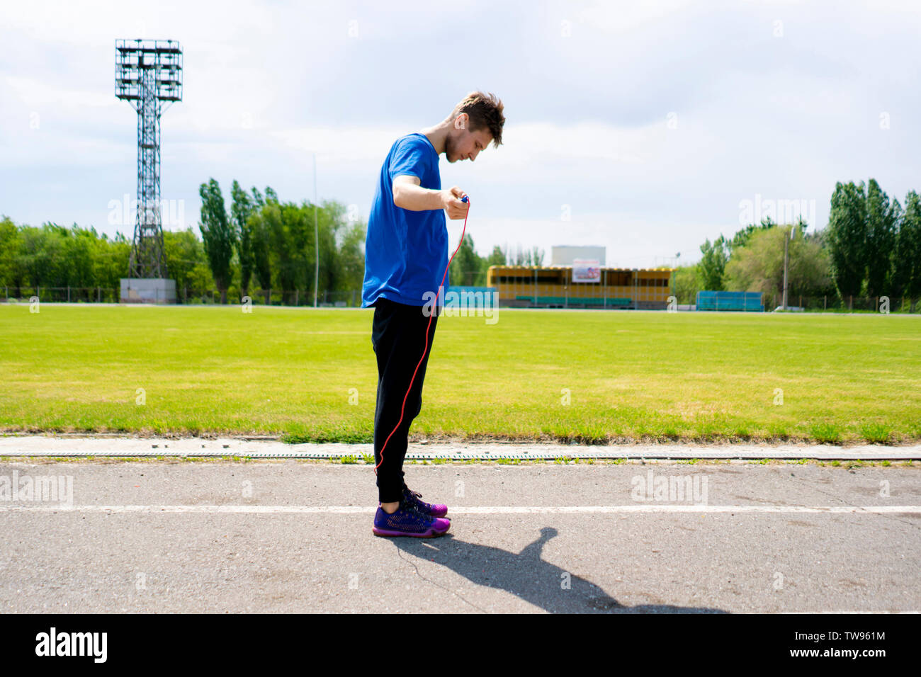 male athlete sportsman practice with jump rope at the outdoor stadium ...