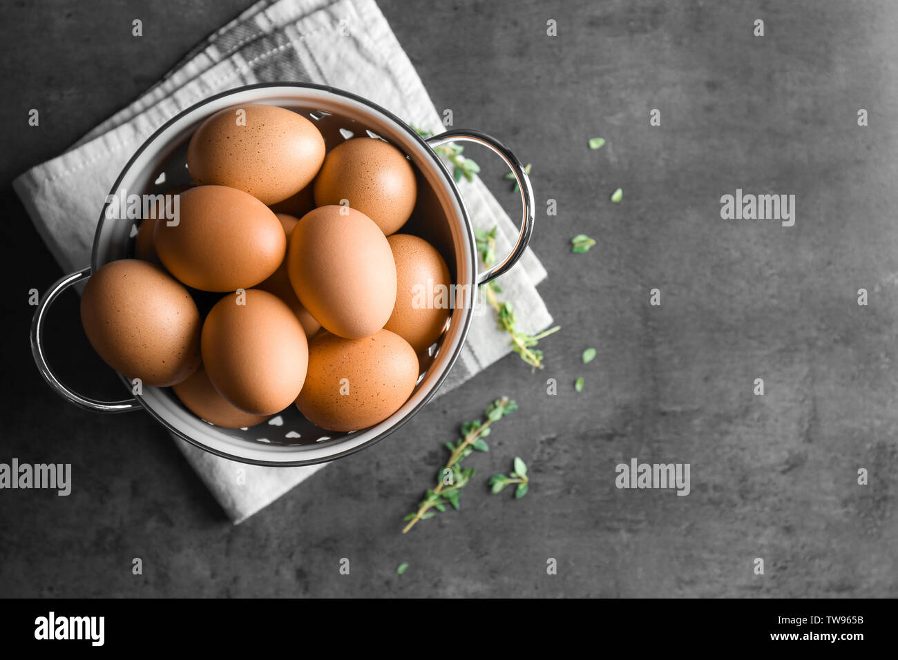 Chicken eggs in colander on table Stock Photo - Alamy