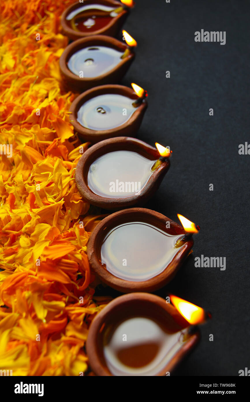 Diwali diyas burning in a row Stock Photo - Alamy