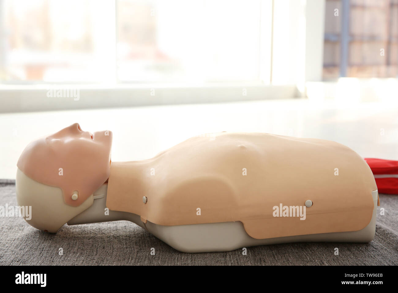 First aid mannequin on floor indoors Stock Photo - Alamy