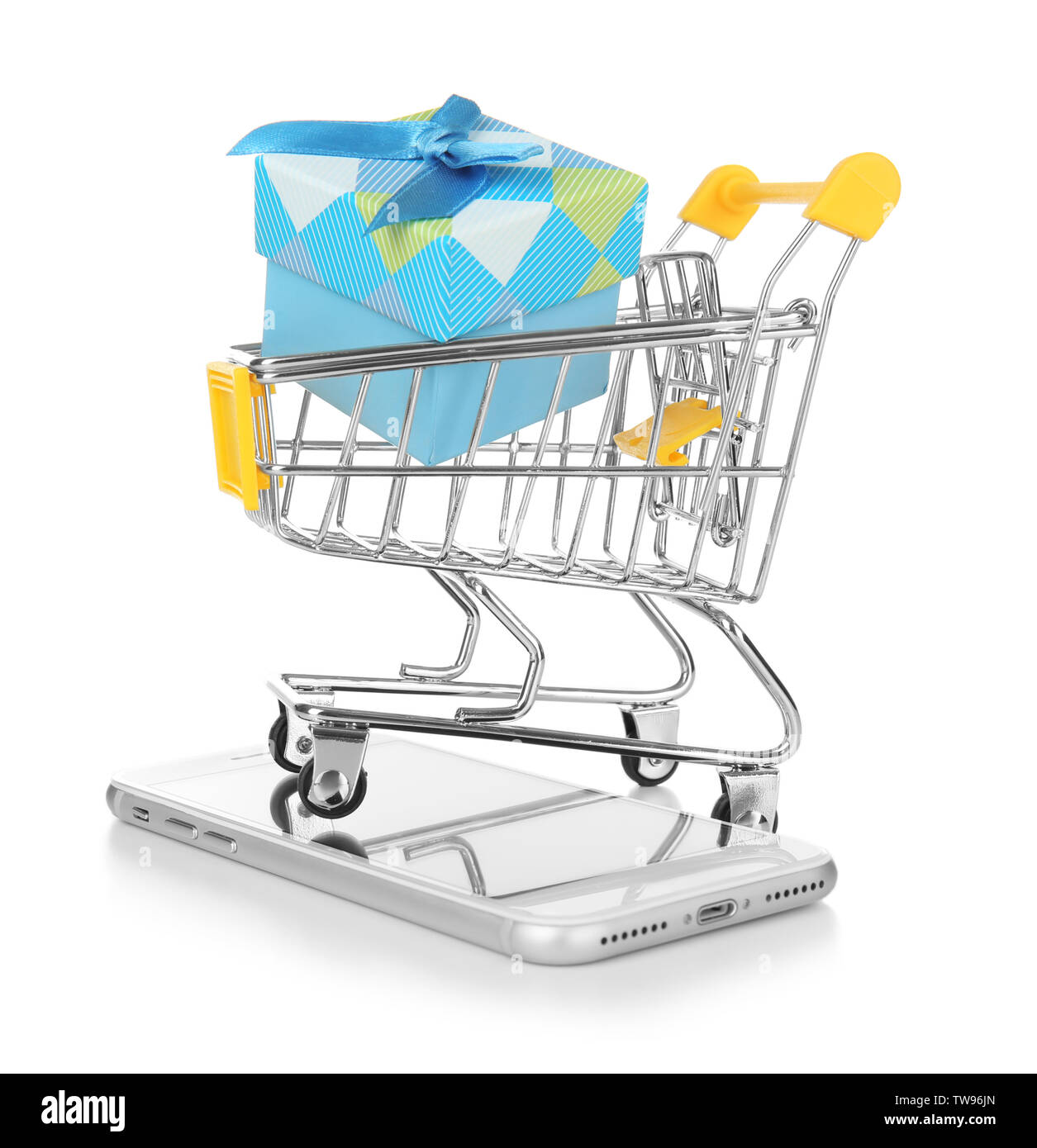 Mobile phone and small shopping cart with gift box on white background ...