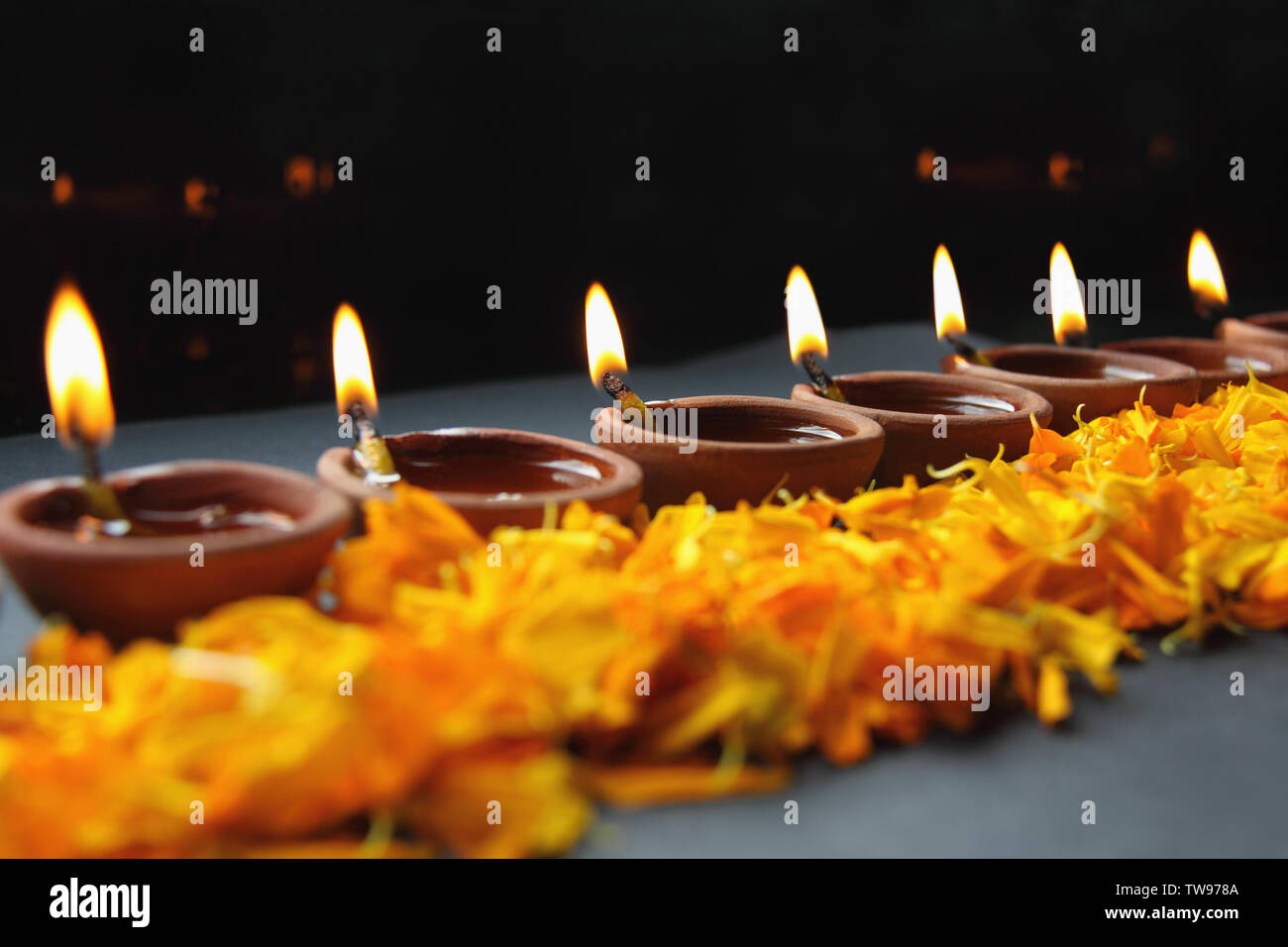 Diwali diyas burning in a row Stock Photo - Alamy