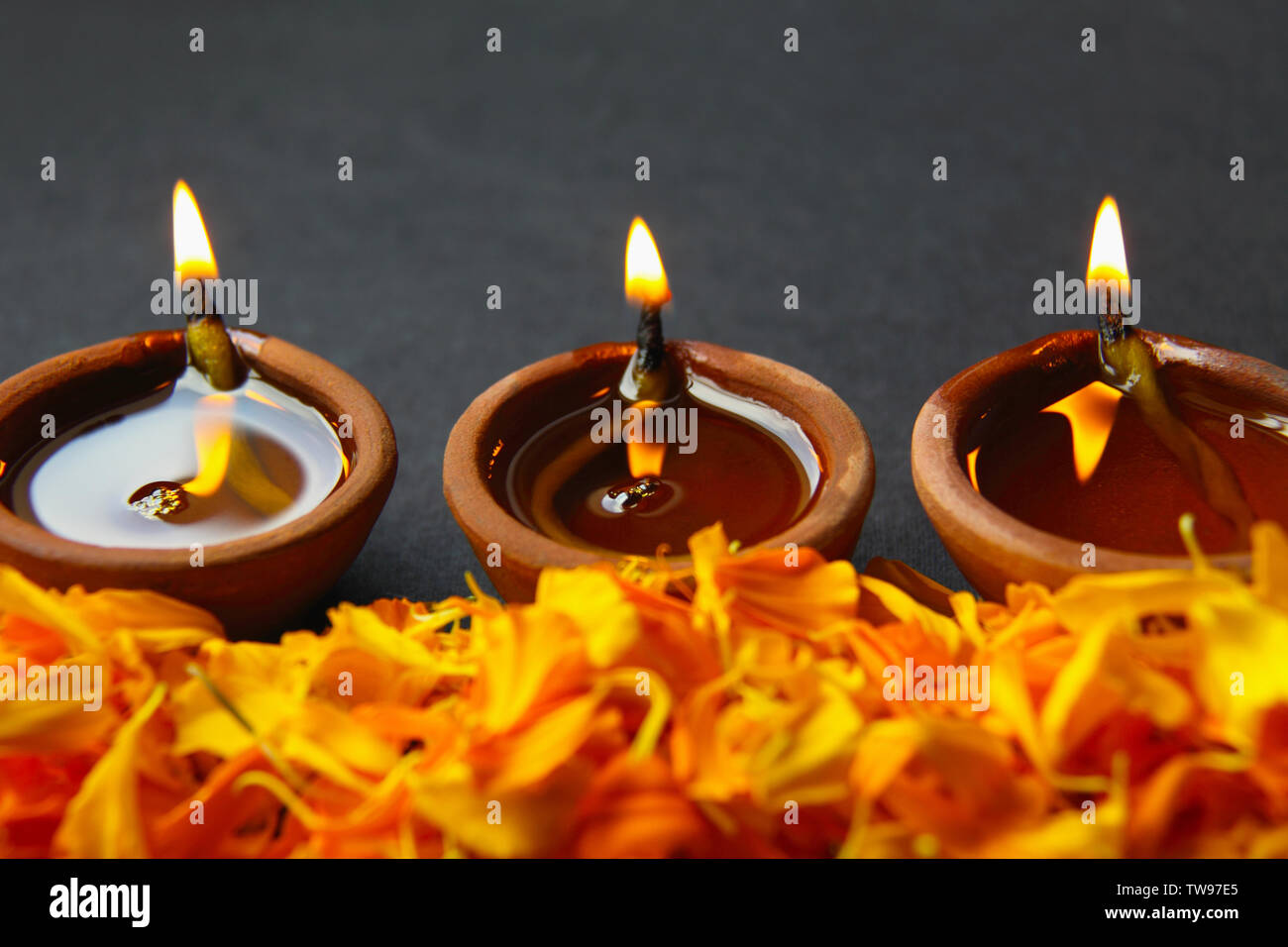 Diwali diyas burning in a row Stock Photo - Alamy