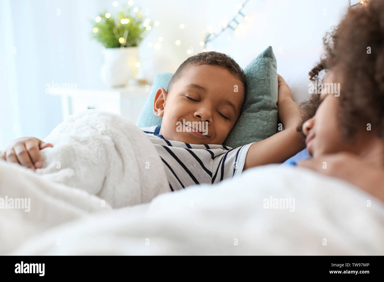 Cute African American children sleeping in bed. Family bedtime Stock ...
