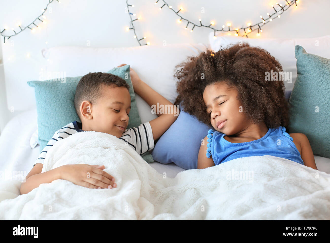 Cute African American children sleeping in bed. Family bedtime Stock ...