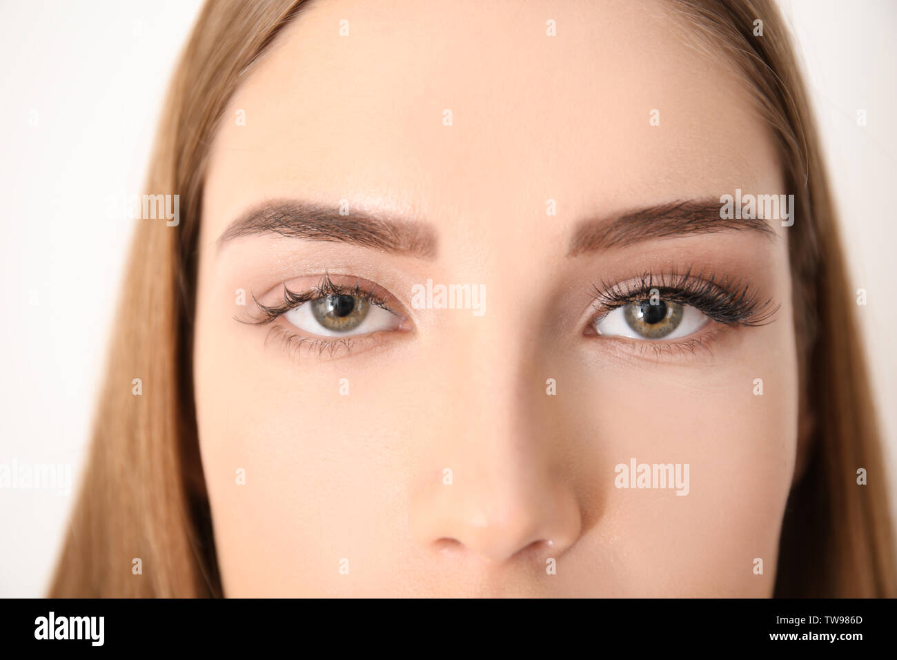 Young woman with eyelash loss problem on white background Stock Photo ...
