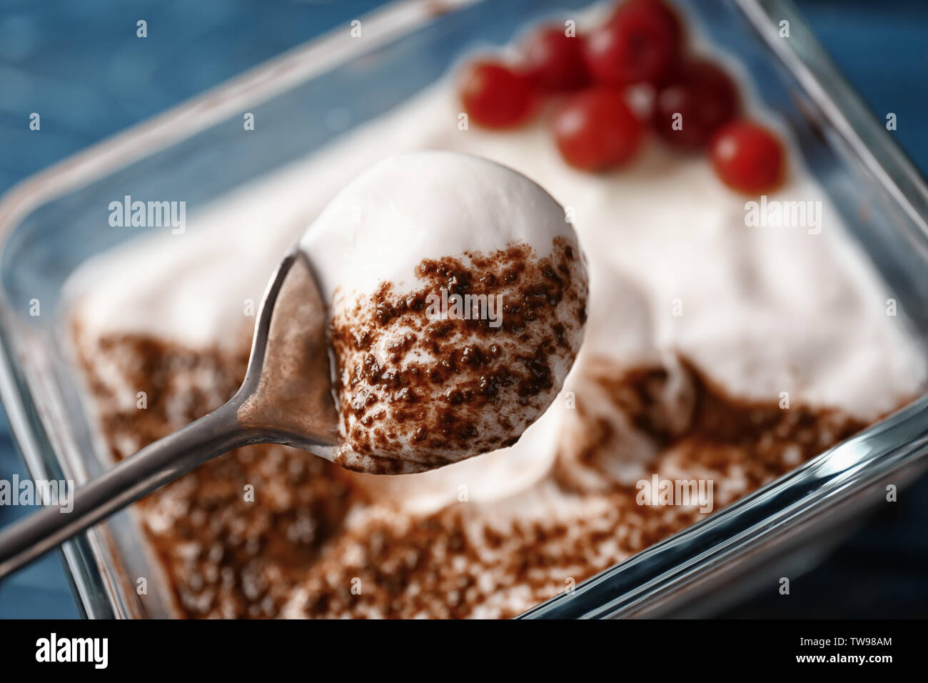 Spoon with tasty vanilla pudding over bowl, closeup Stock Photo - Alamy