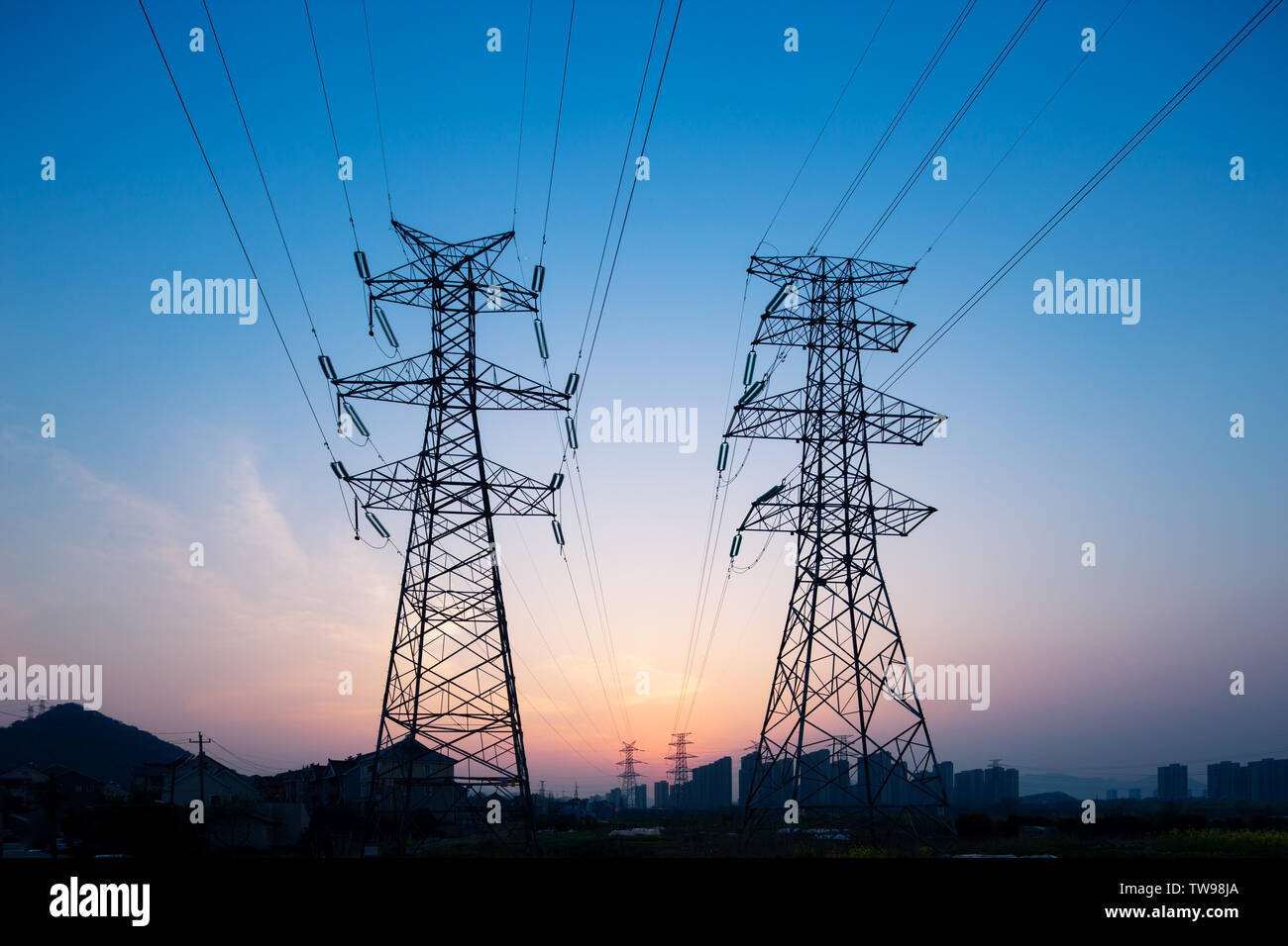 Pylons in blue sky at sunrise Stock Photo - Alamy