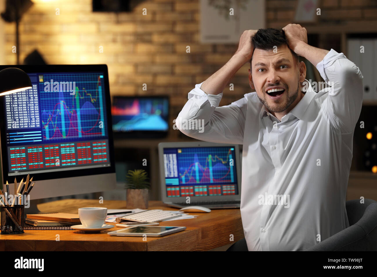 Emotional stock exchange trader at workplace Stock Photo - Alamy