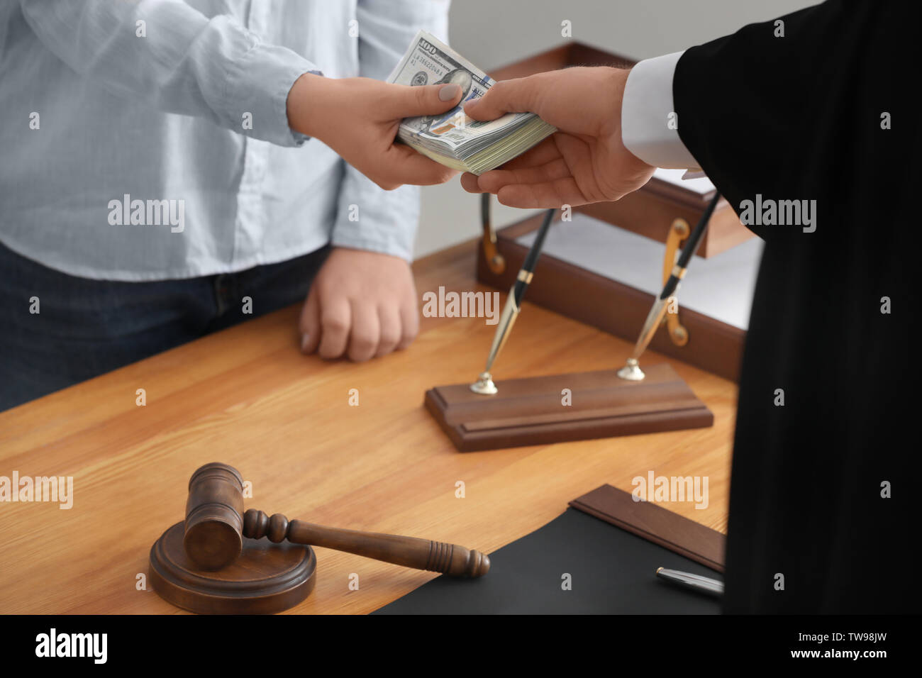 Judge taking bribe from woman, closeup Stock Photo - Alamy