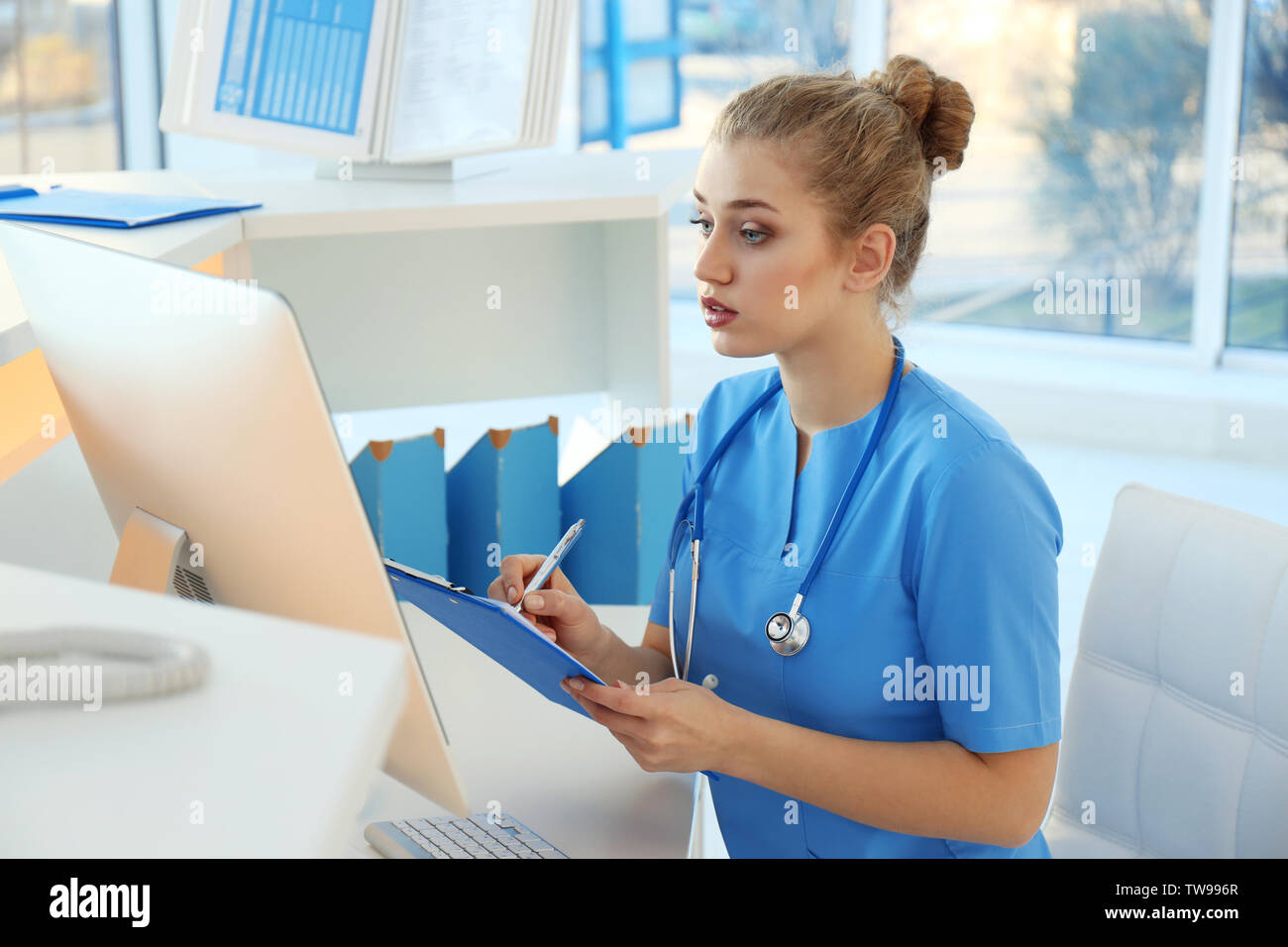 Female receptionist working in hospital Stock Photo - Alamy