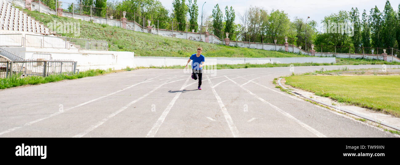 fast speed runner on the stadium sport track outdoor before the ...