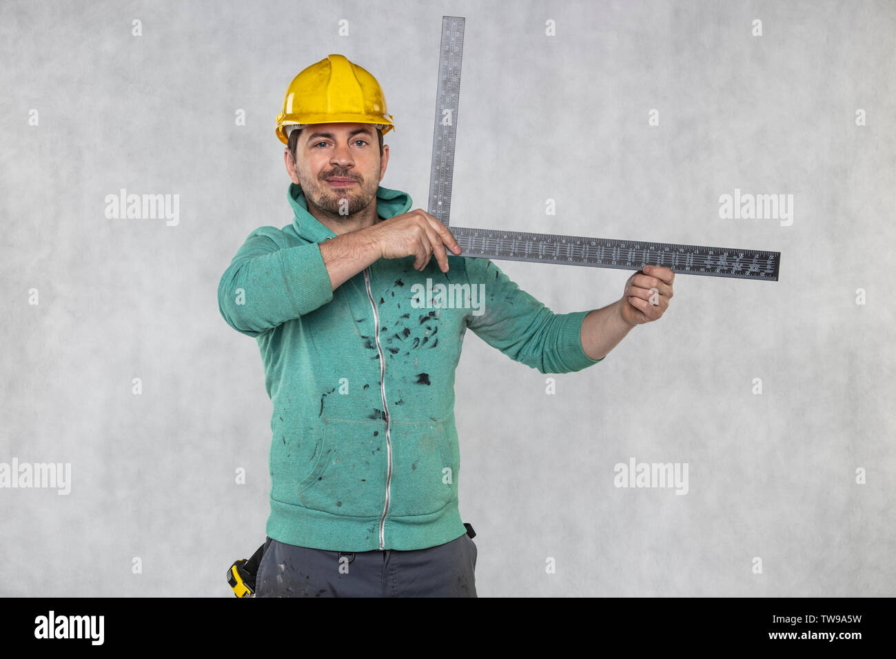 the construction worker is holding a angle in the hand, a guide to ...