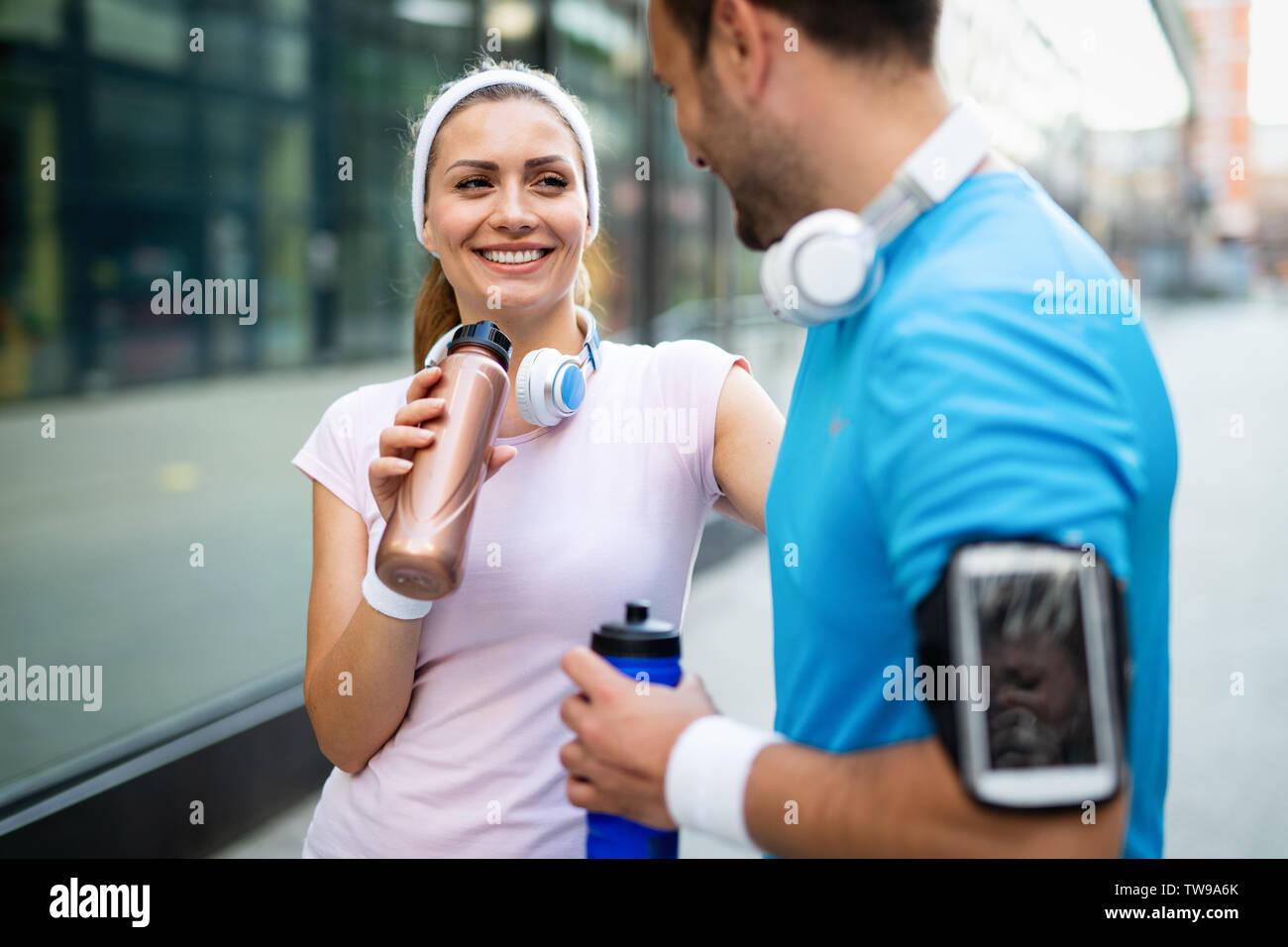 Fitness sporty couple relaxing after running training outside Stock Photo - Alamy