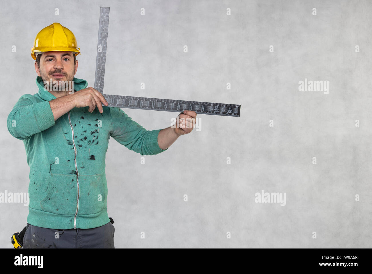 the construction worker is holding a angle in the hand, a guide to ...