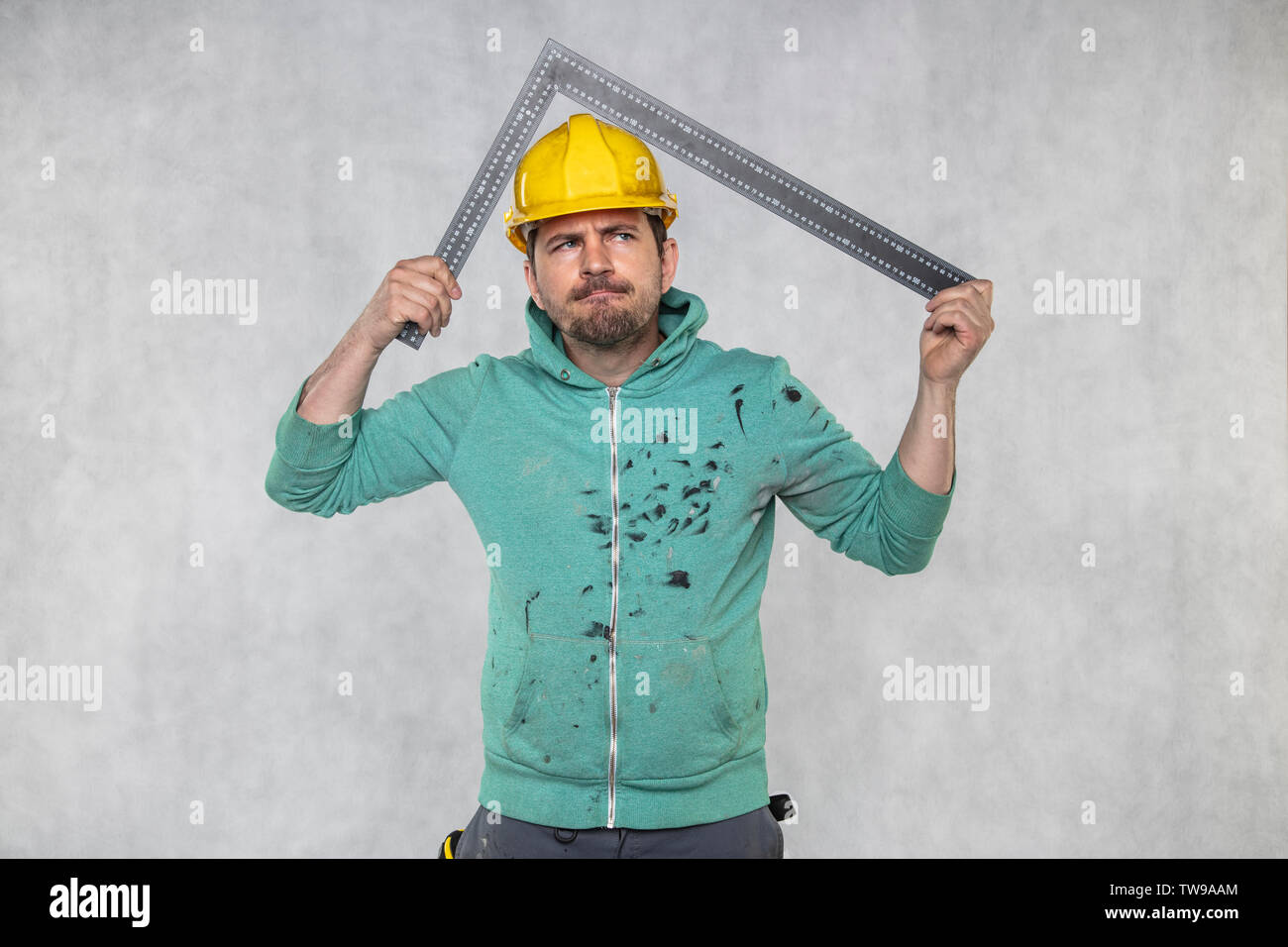 the construction worker is holding a angle in the hand, a guide to ...