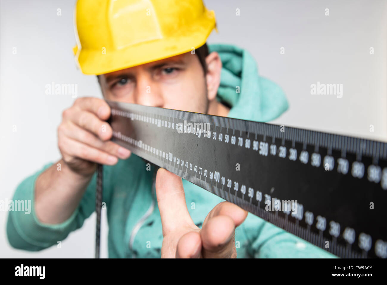 the construction worker is holding a angle in the hand, a guide to ...