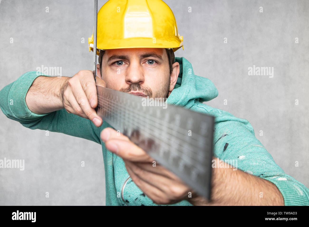 the construction worker is holding a angle in the hand, a guide to ...