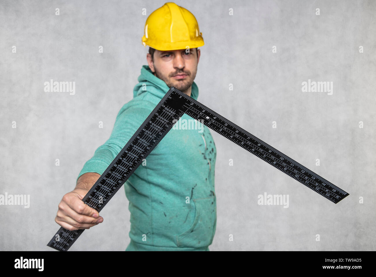 the construction worker is holding a angle in the hand, a guide to ...
