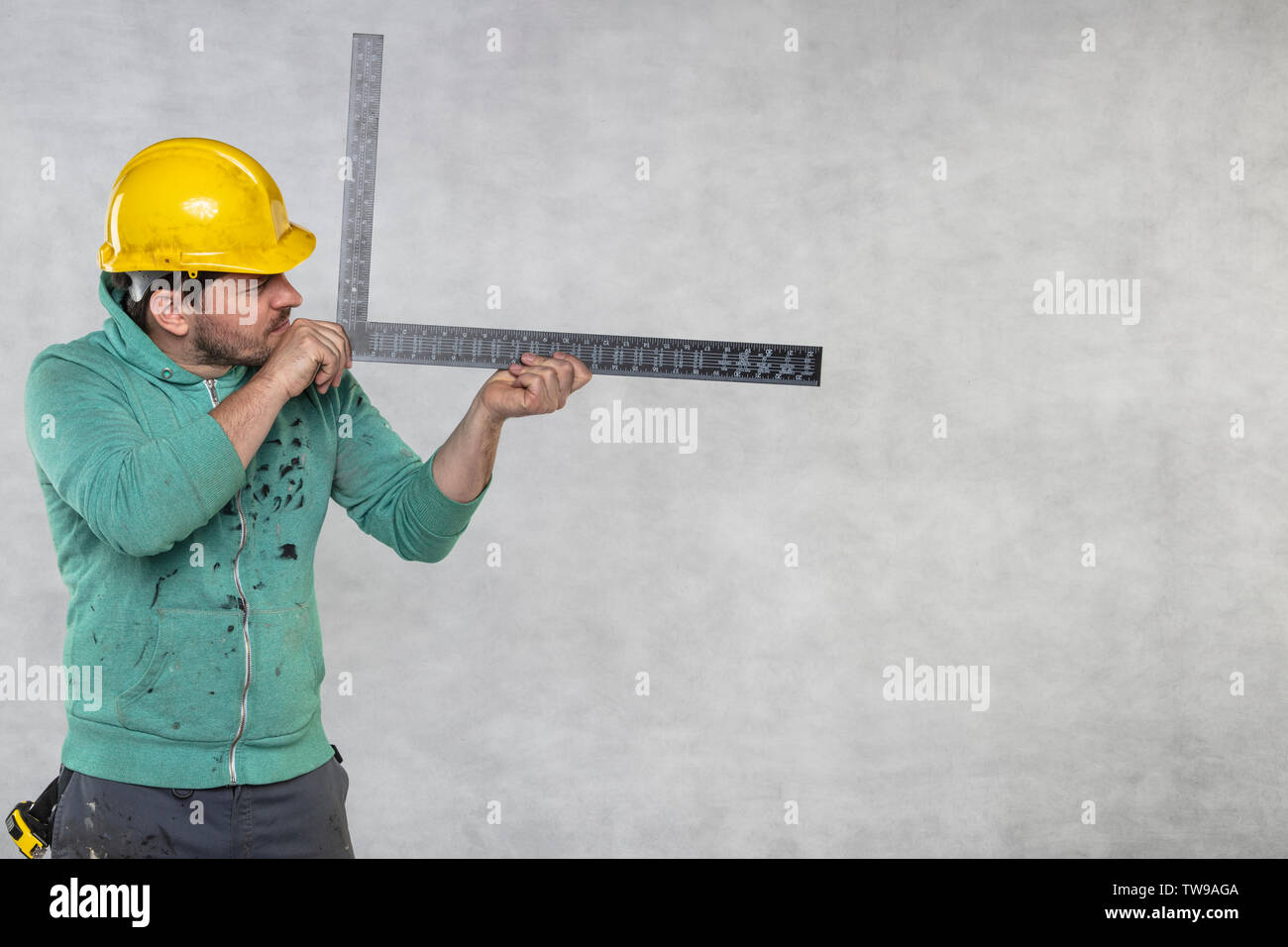 the construction worker is holding a angle in the hand, a guide to ...