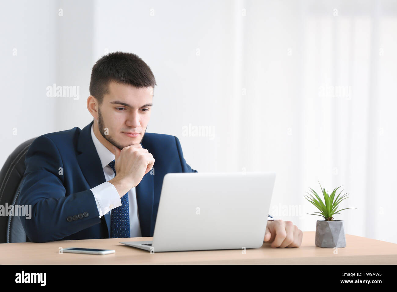 Young man in suit using hi-res stock photography and images - Alamy