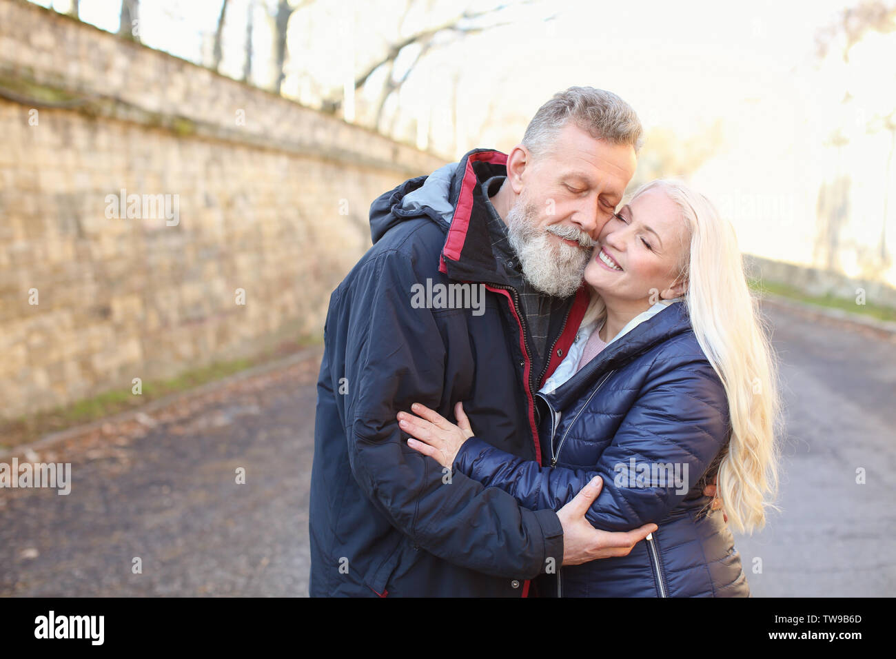 Happy mature couple hugging outdoors Stock Photo - Alamy