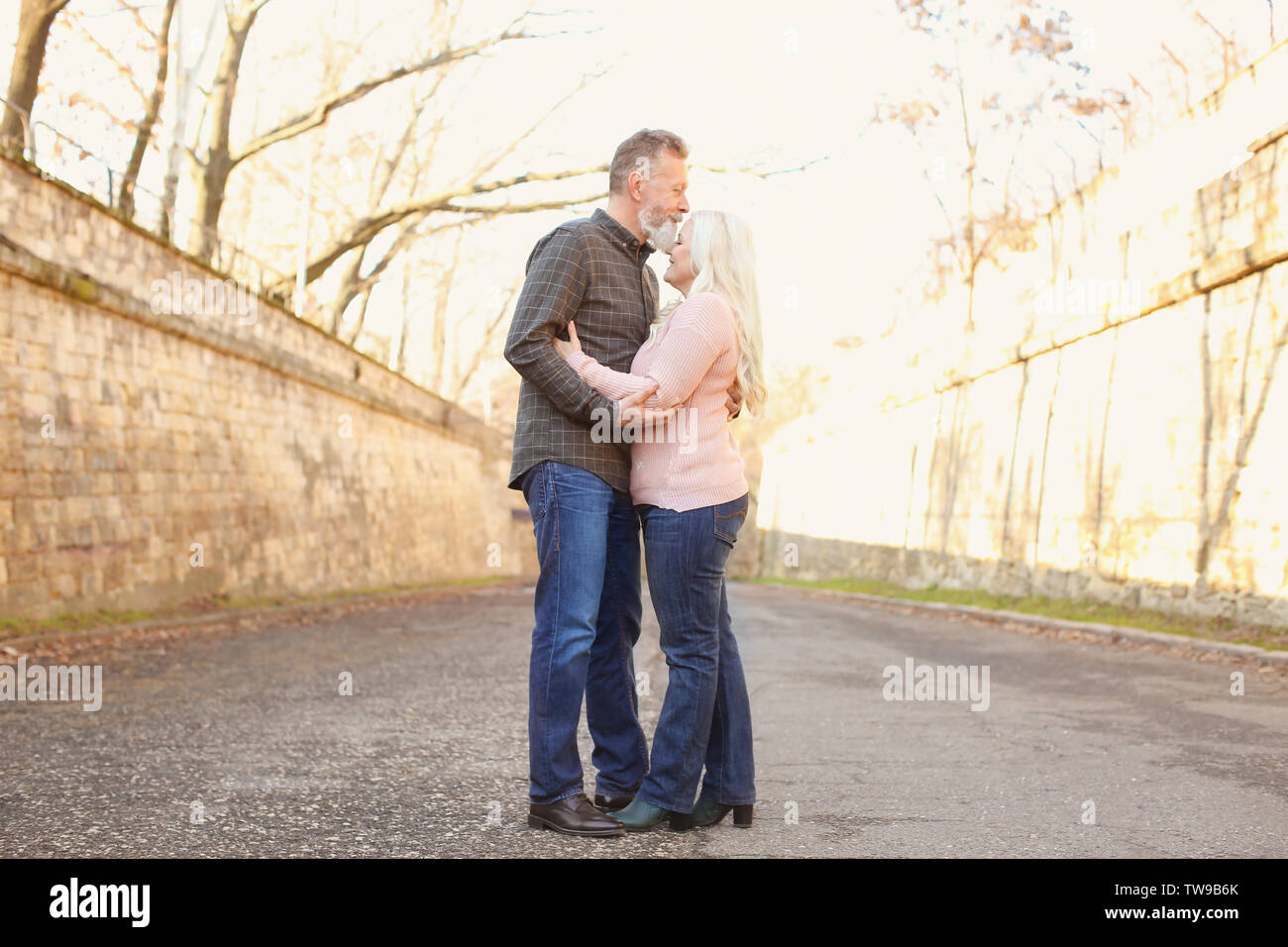 Happy mature couple hugging outdoors Stock Photo - Alamy