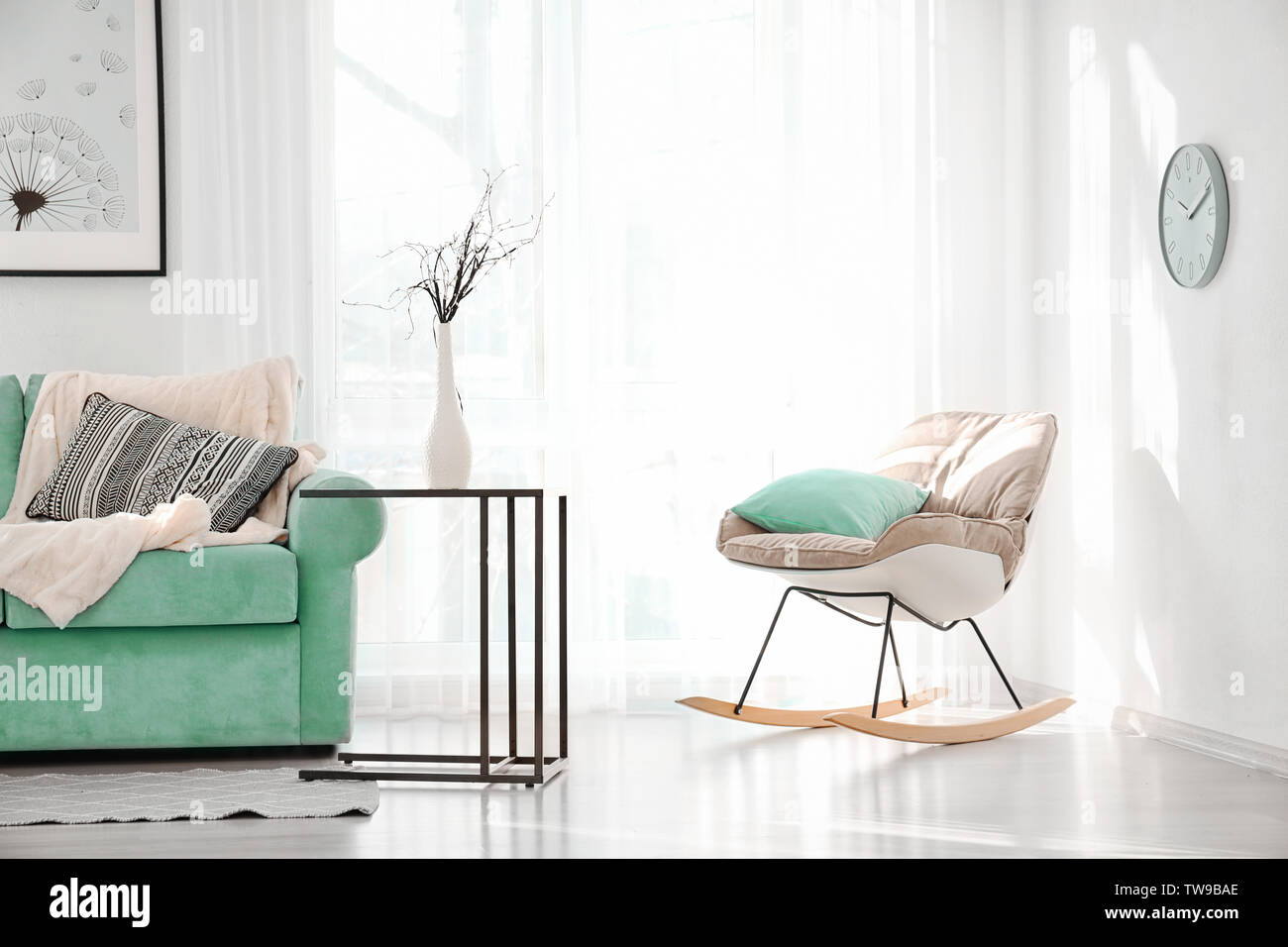 Living room interior with comfortable mint couch and rocking chair ...
