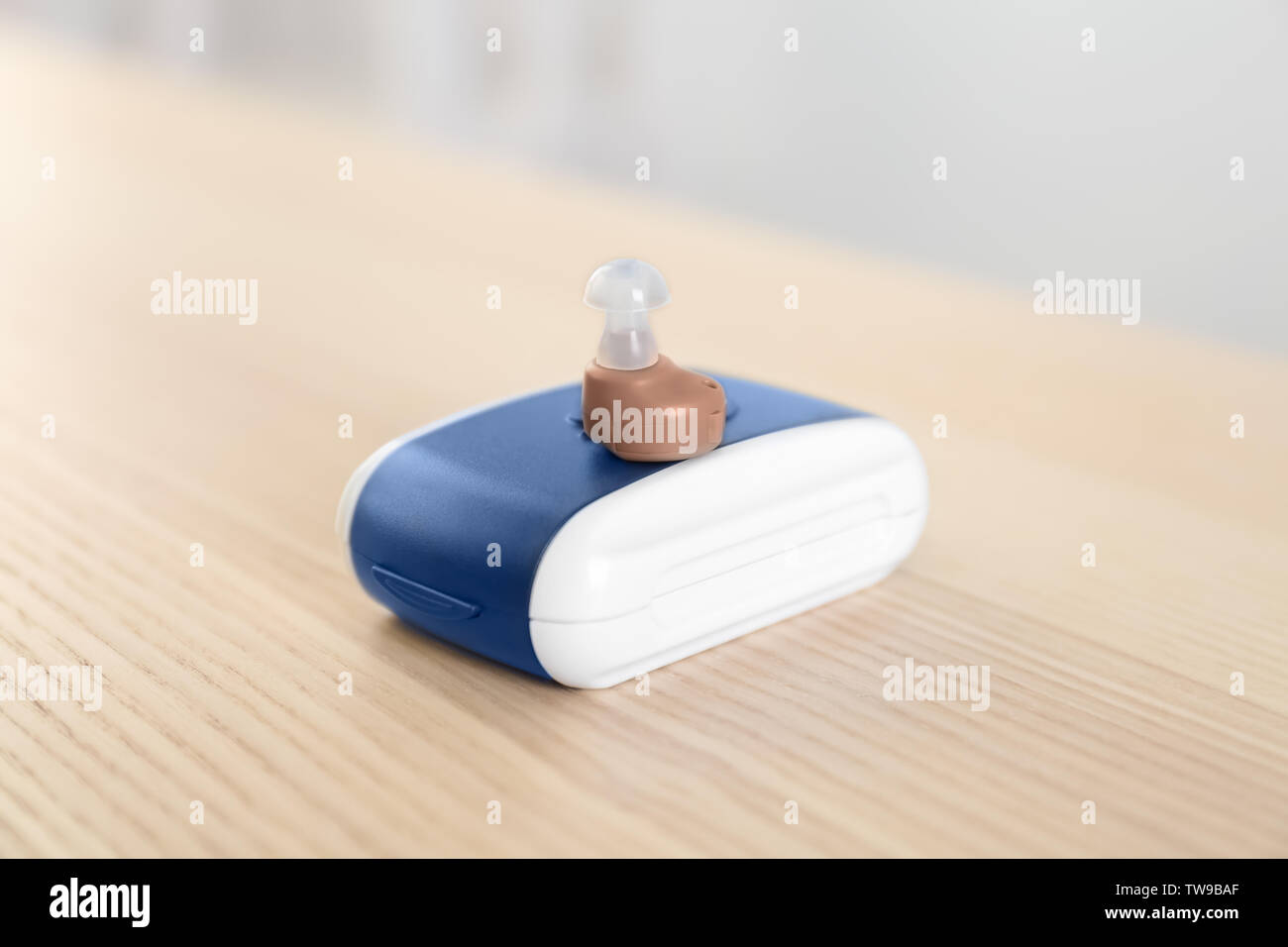 Hearing aid and box on table, closeup Stock Photo - Alamy