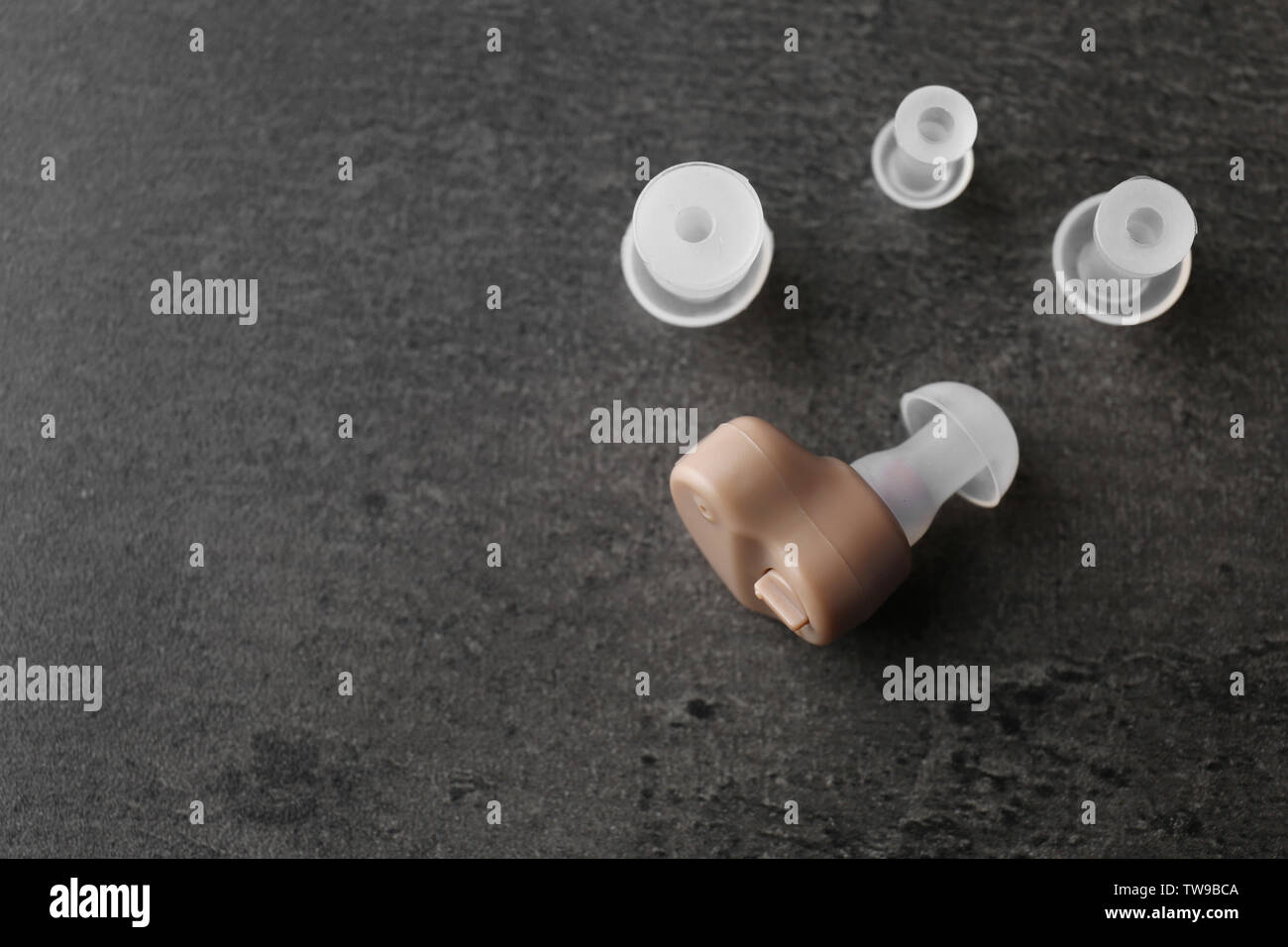 Composition with hearing aid and tips on grey background Stock Photo ...