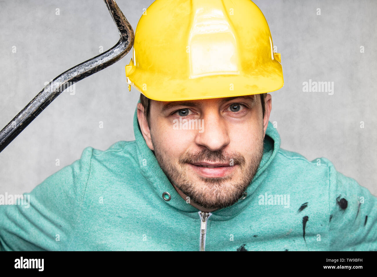 the construction worker holds a work tool in his hands, a crowbar Stock ...
