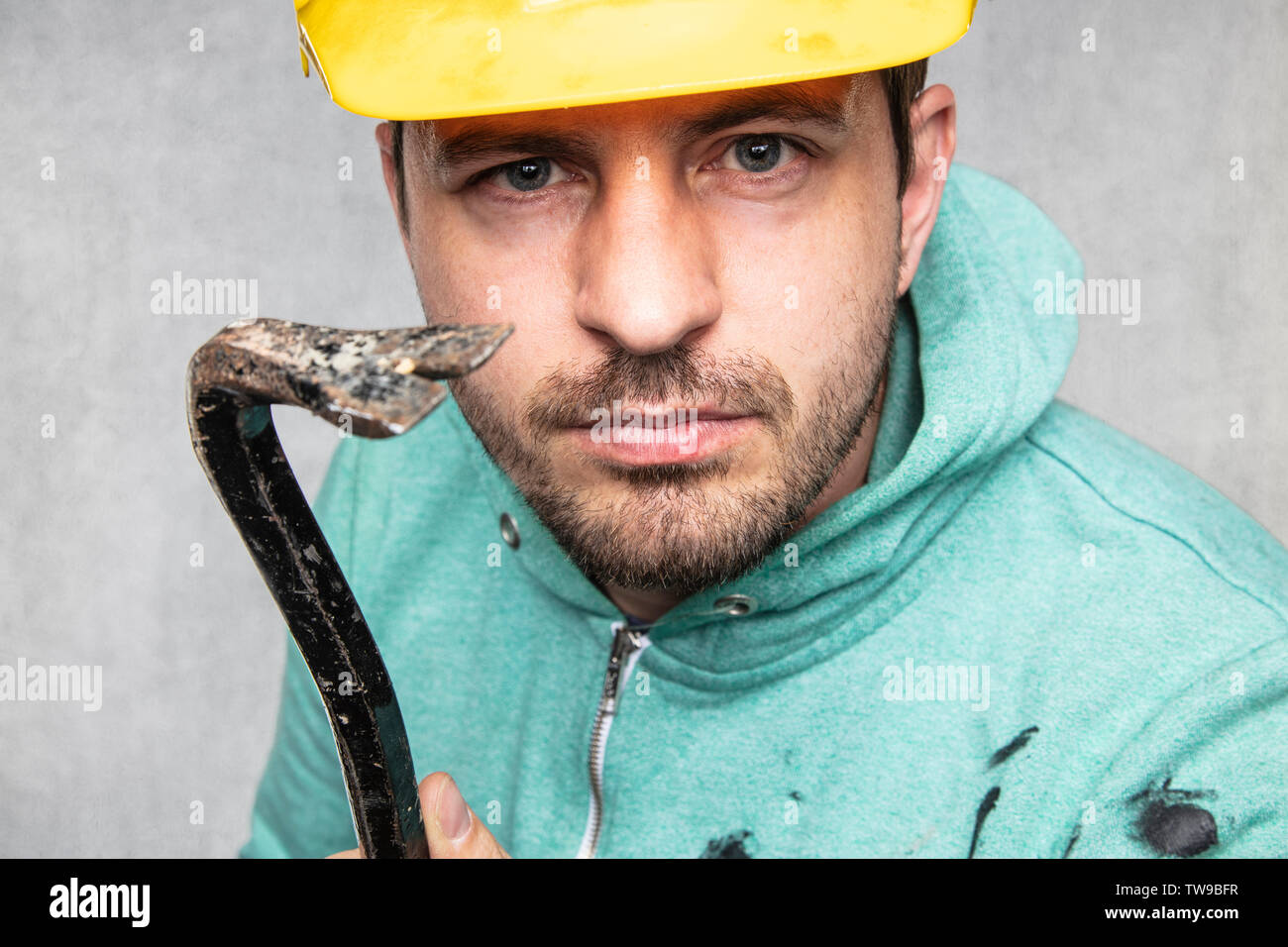 the construction worker holds a work tool in his hands, a crowbar Stock ...