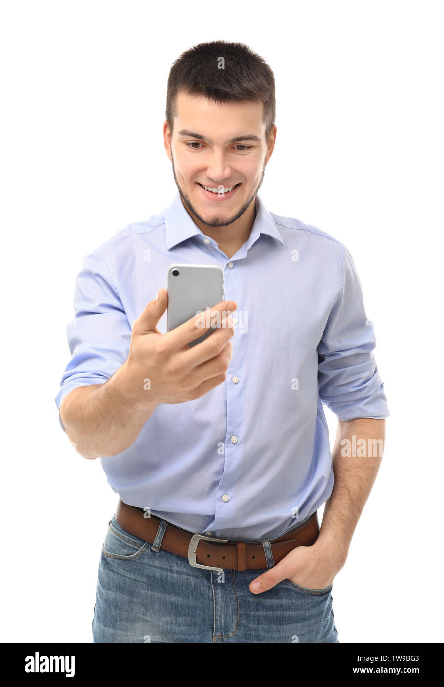 Young man using cell phone against white background Stock Photo - Alamy