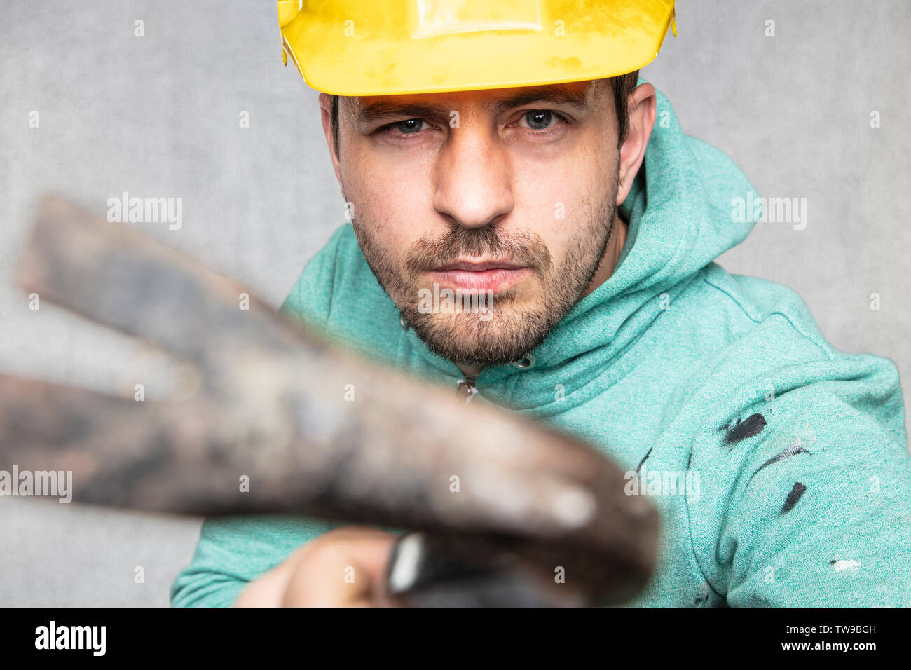 the construction worker holds a work tool in his hands, a crowbar Stock ...