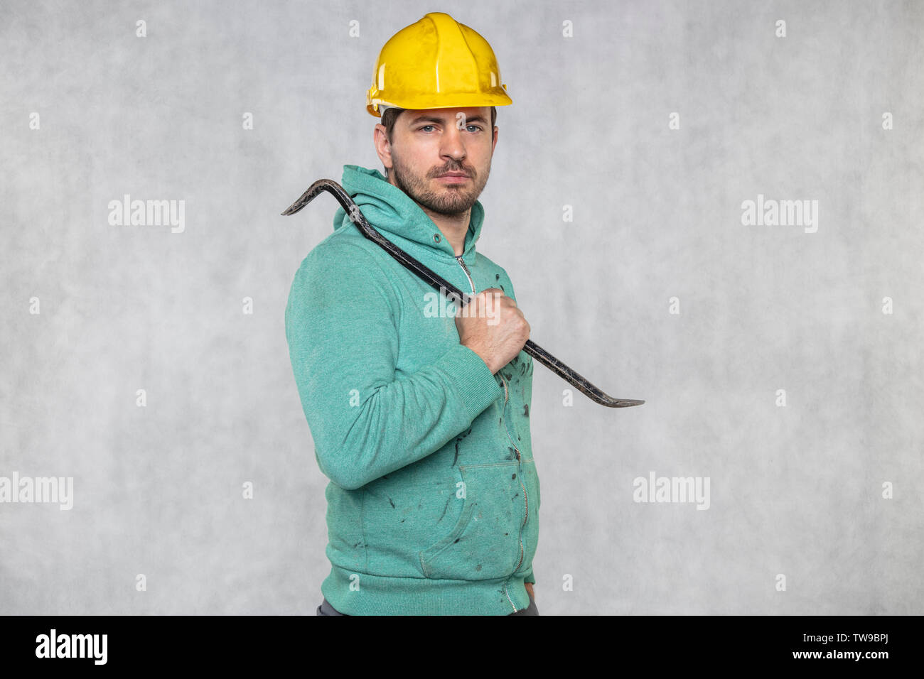 the construction worker holds a work tool in his hands, a crowbar Stock ...