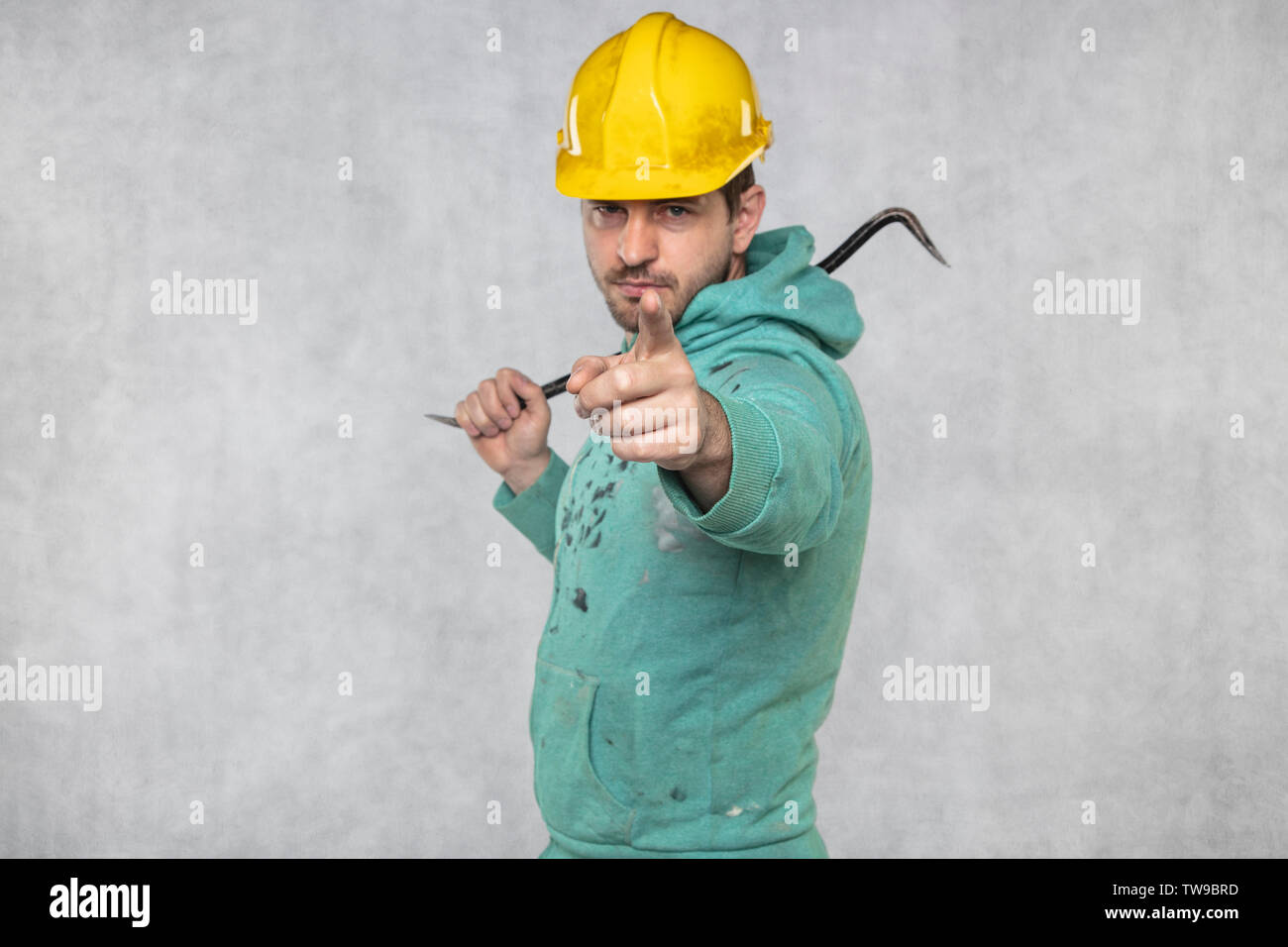 the construction worker holds a work tool in his hands, a crowbar Stock ...