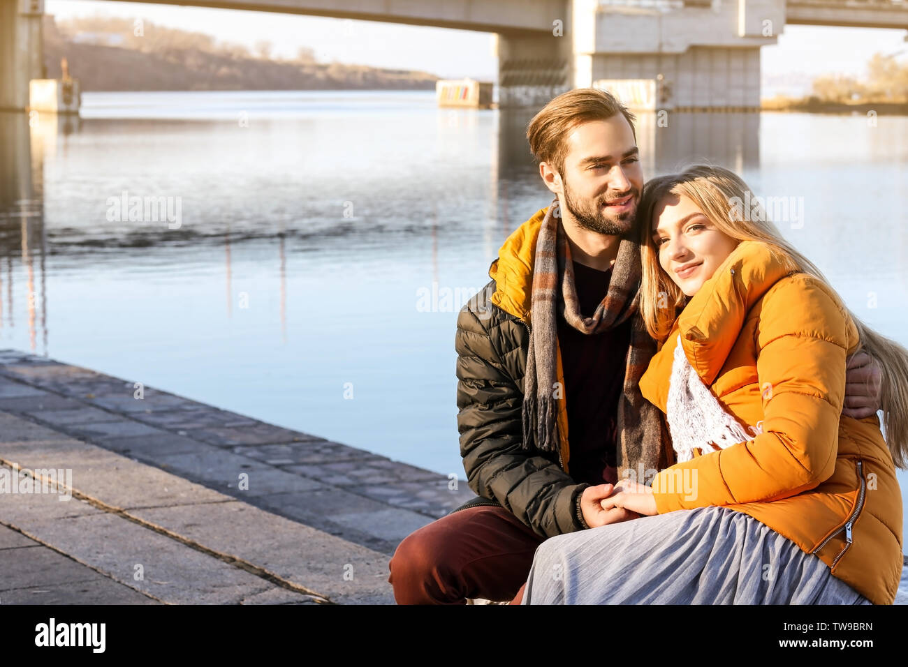 Loving couple sitting on river hi-res stock photography and images - Alamy