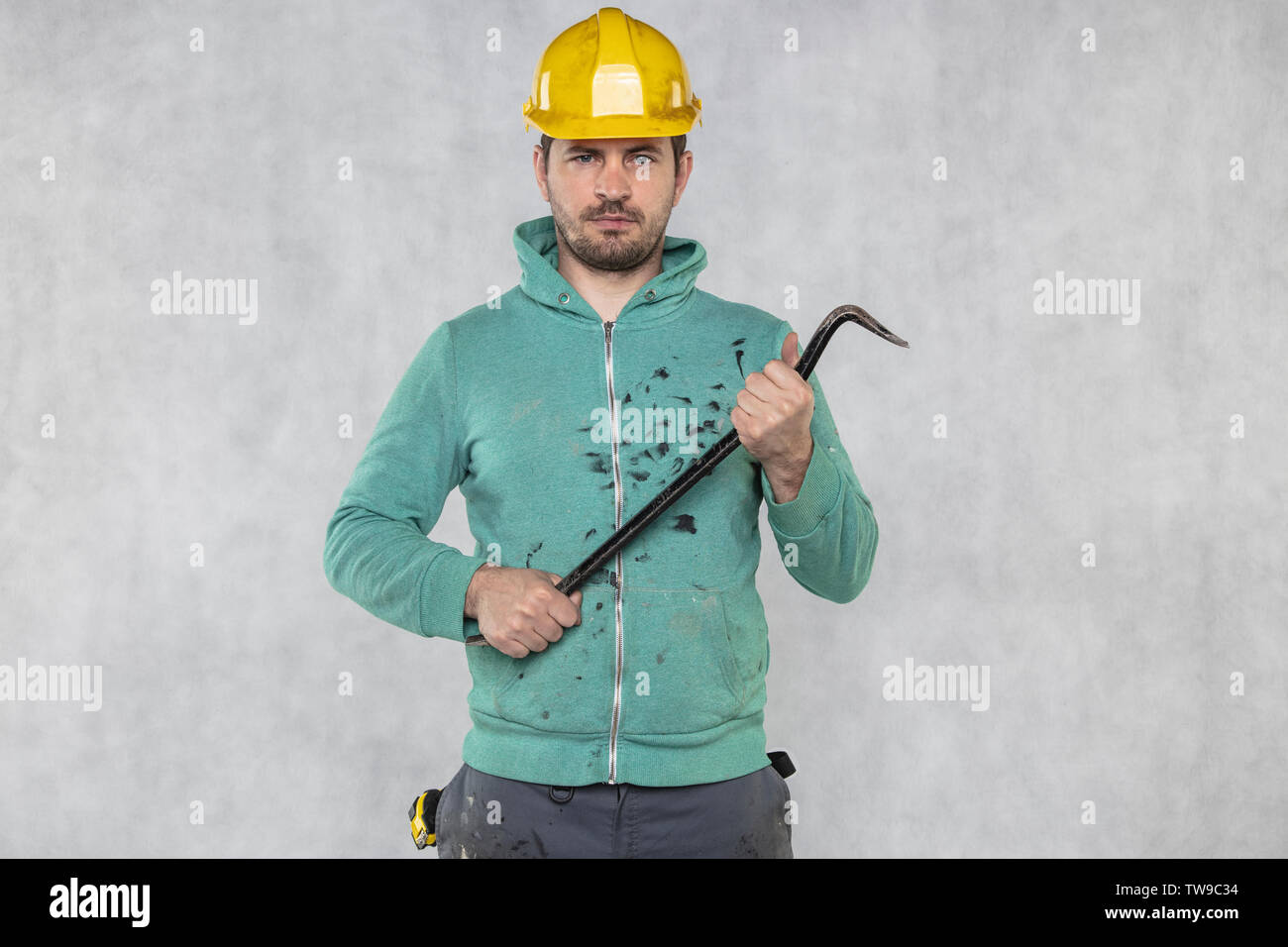 the construction worker holds a work tool in his hands, a crowbar Stock ...