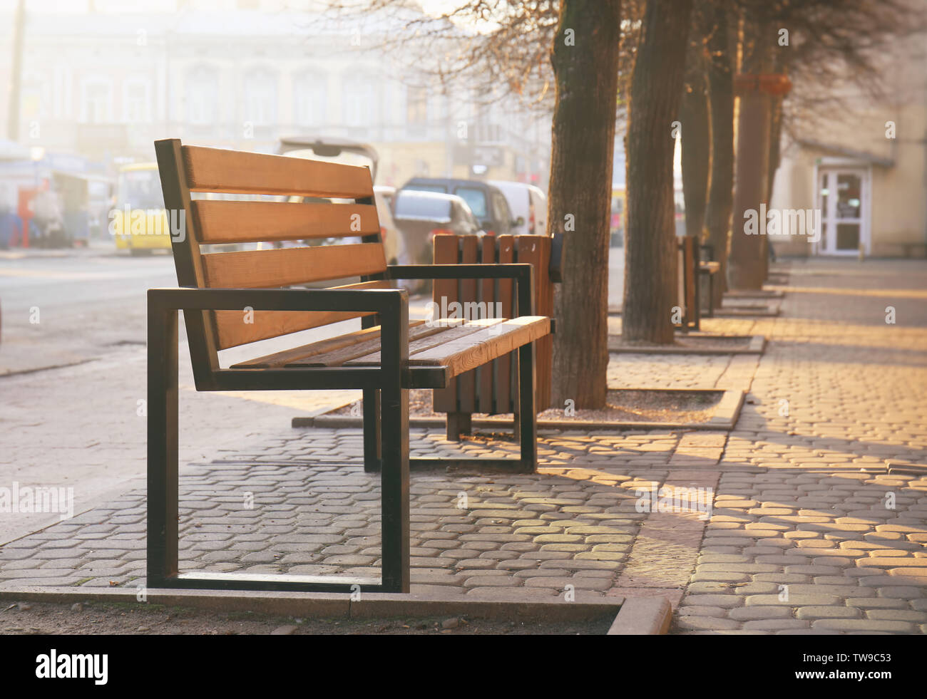 Bench on sidewalk hi-res stock photography and images - Alamy