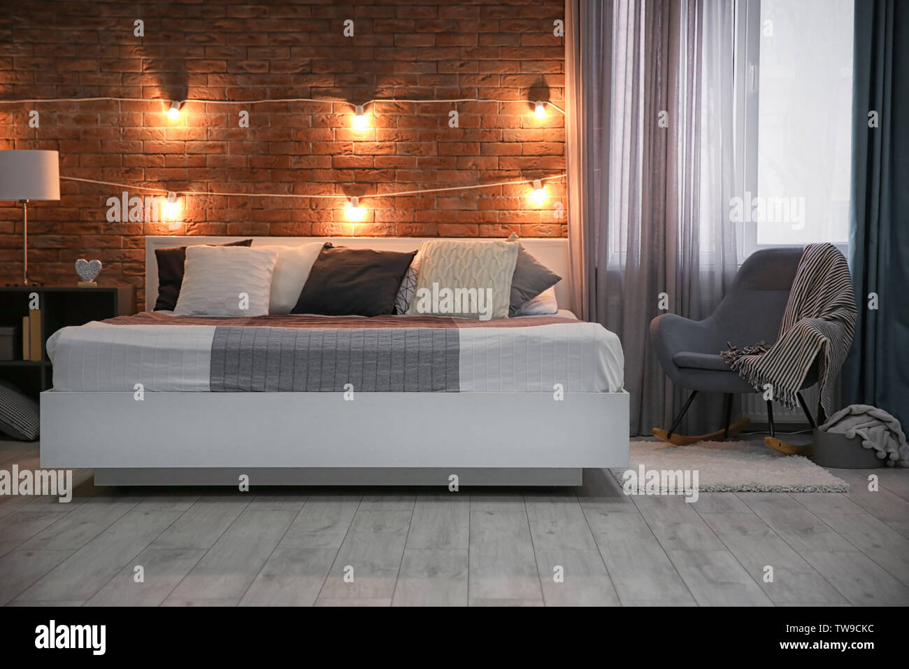 Cozy room interior with comfortable bed Stock Photo - Alamy