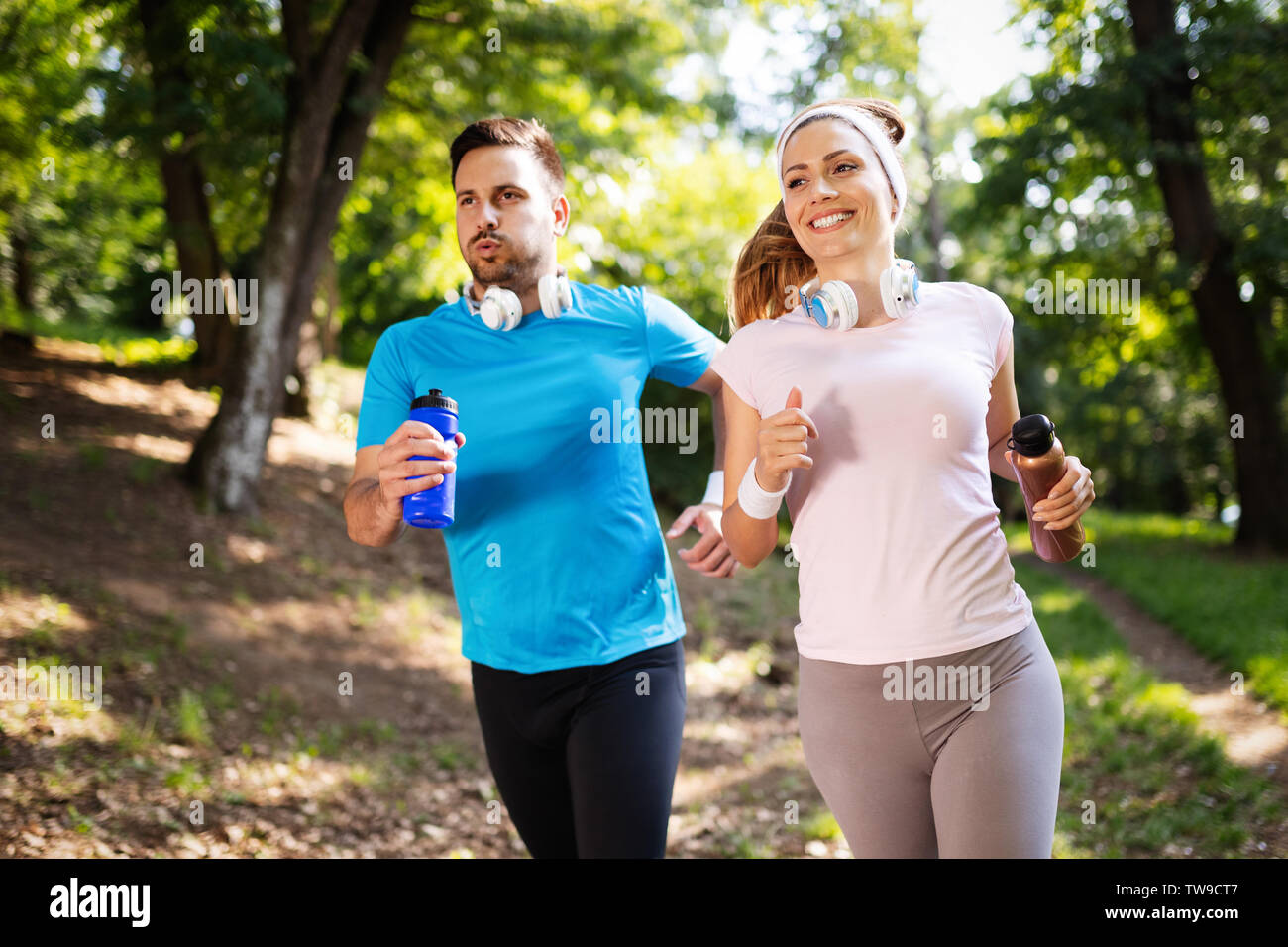 Young fitness couple running forest hi-res stock photography and images ...