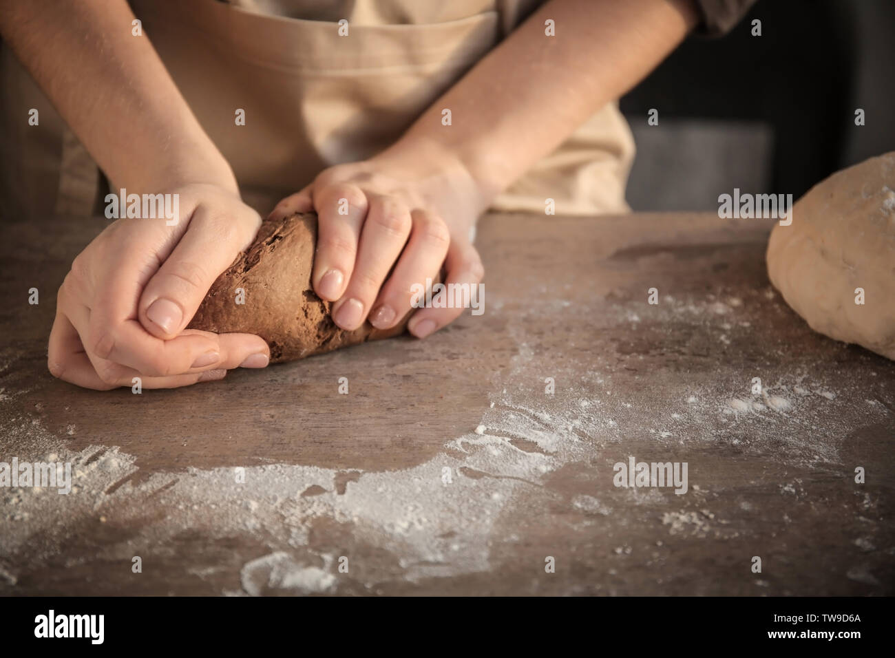 Woman kneading dough on table, closeup Stock Photo - Alamy