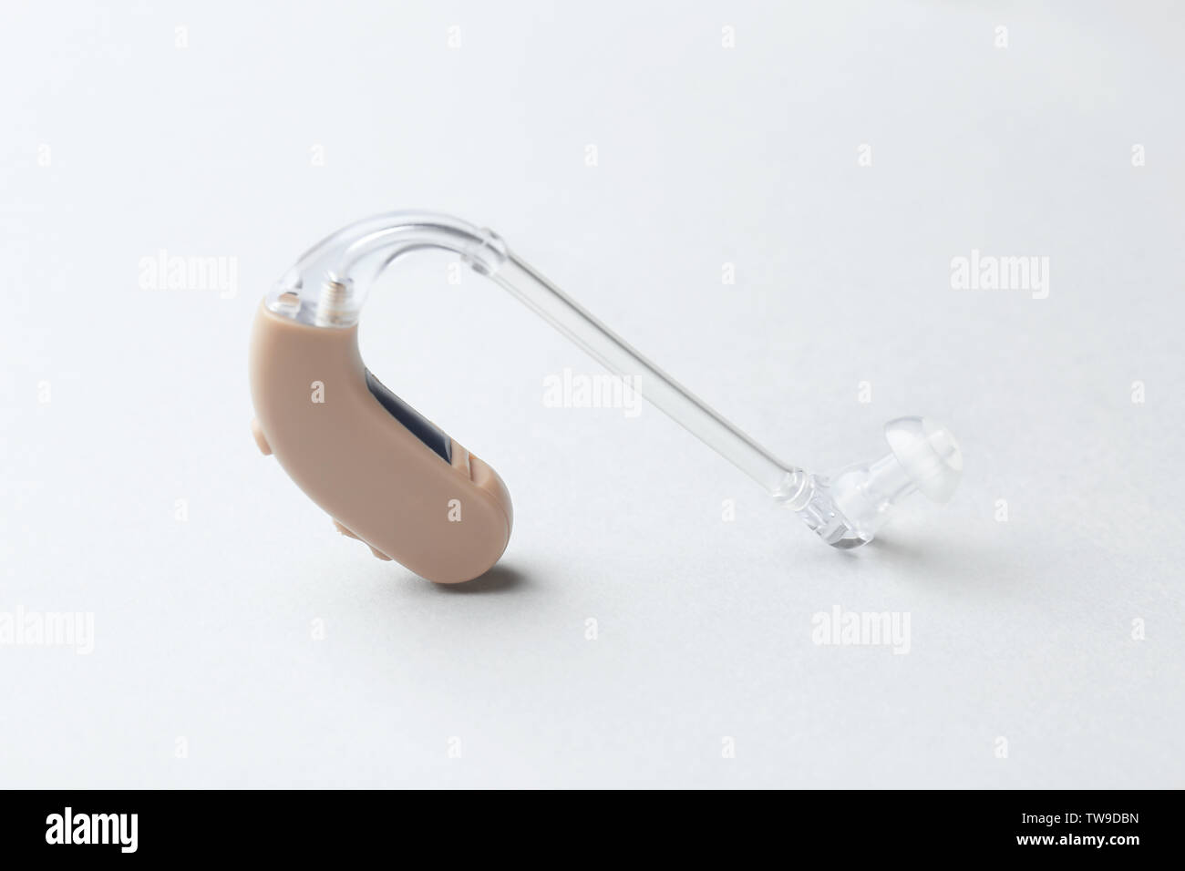 Hearing aid on light background Stock Photo - Alamy